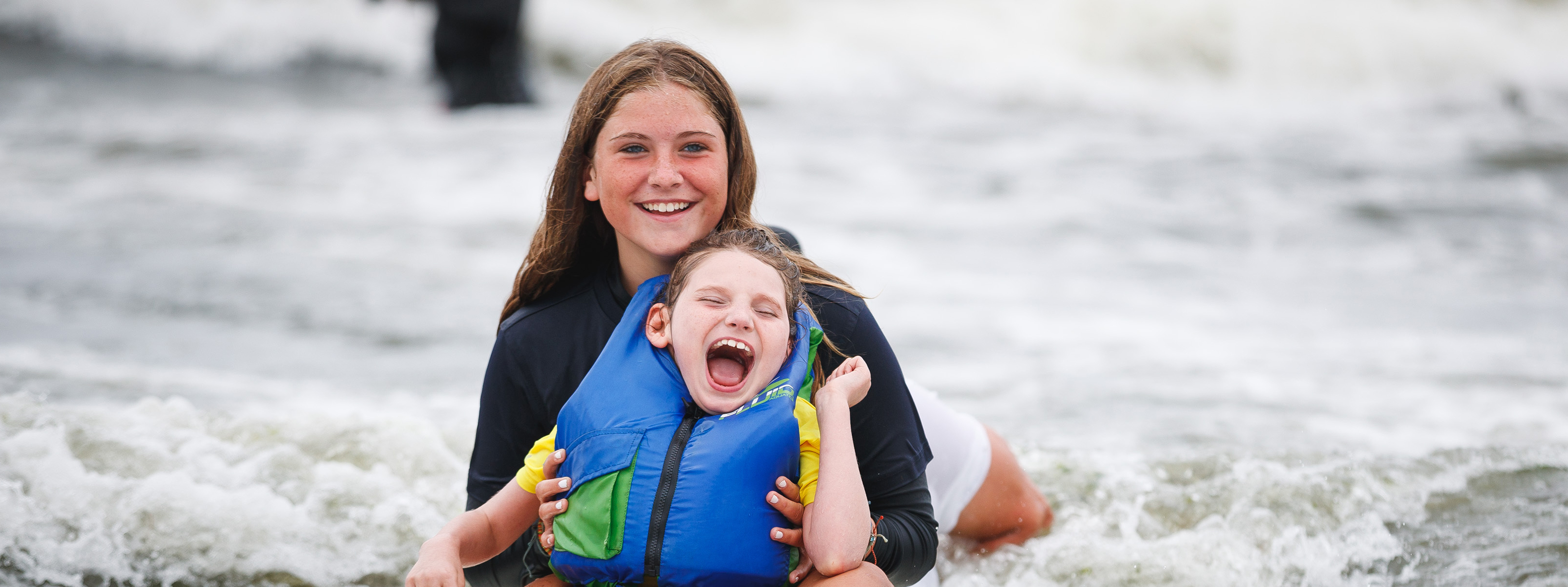 World-class surfers help kids with disabilities ride the waves