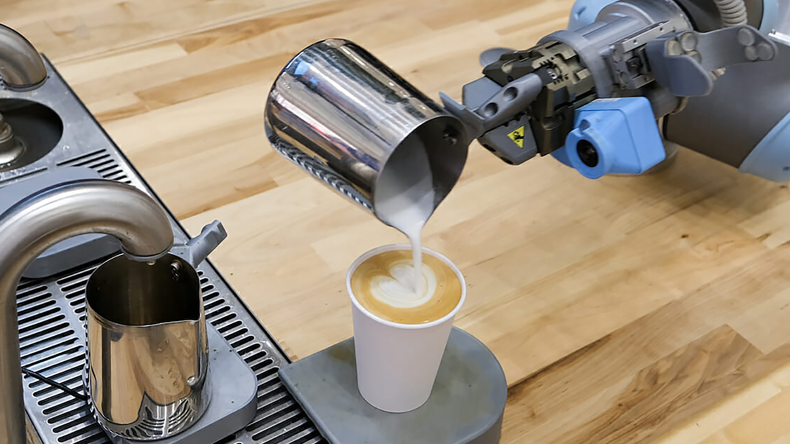 Watch a robot barista create latte art